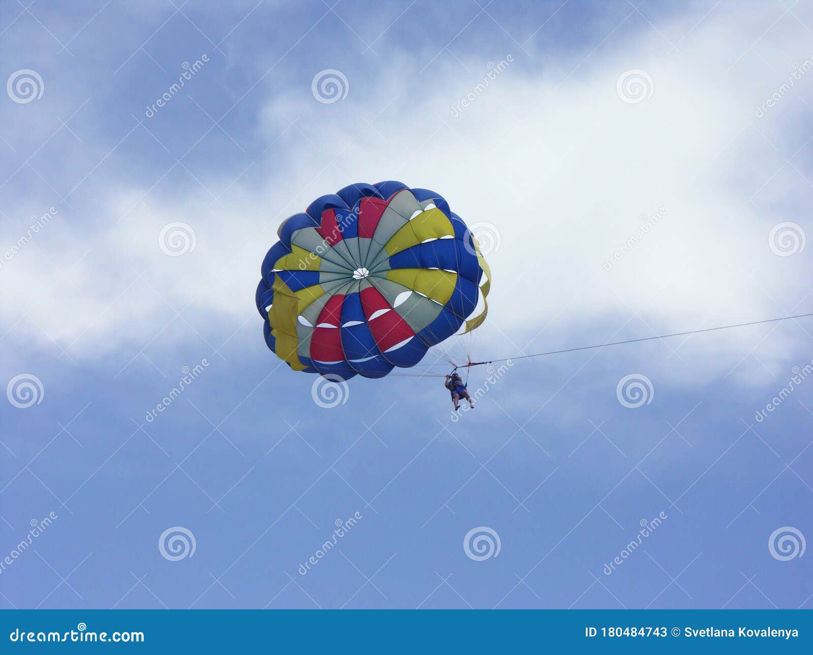 Multi-colored Parachute in the Sky Stock Image - Image of gliding, blue ...