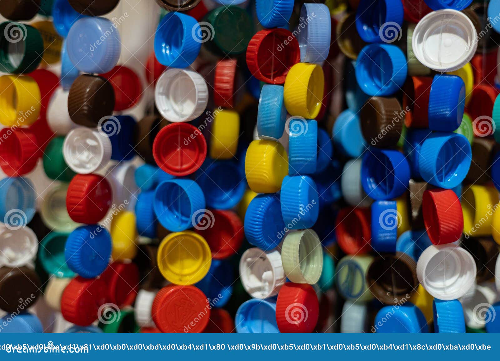 Multi-colored Plastic Caps Hang in a Row on a Thread To Form a ...