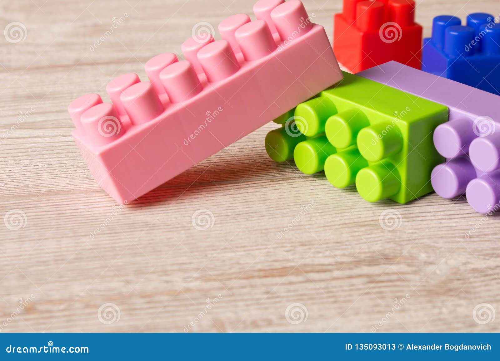 Multi-colored Plastic Construction Set on the Wooden Table . Children`s ...