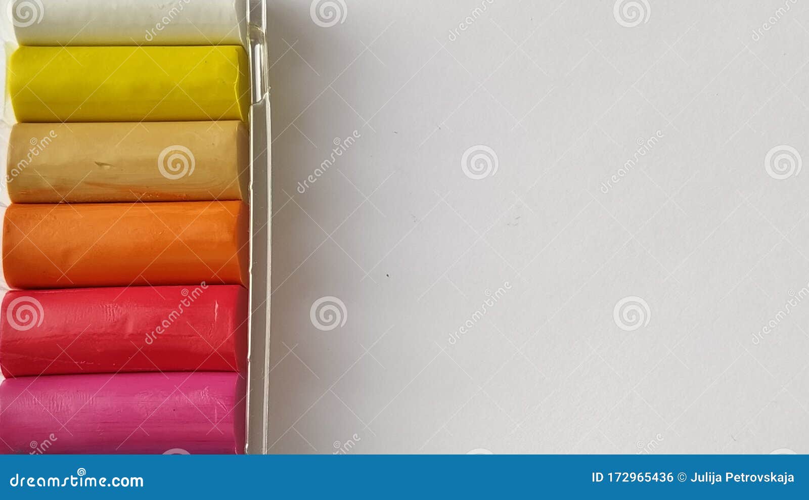 Multi-colored Plasticine in Plastic Packaging on a White Background ...