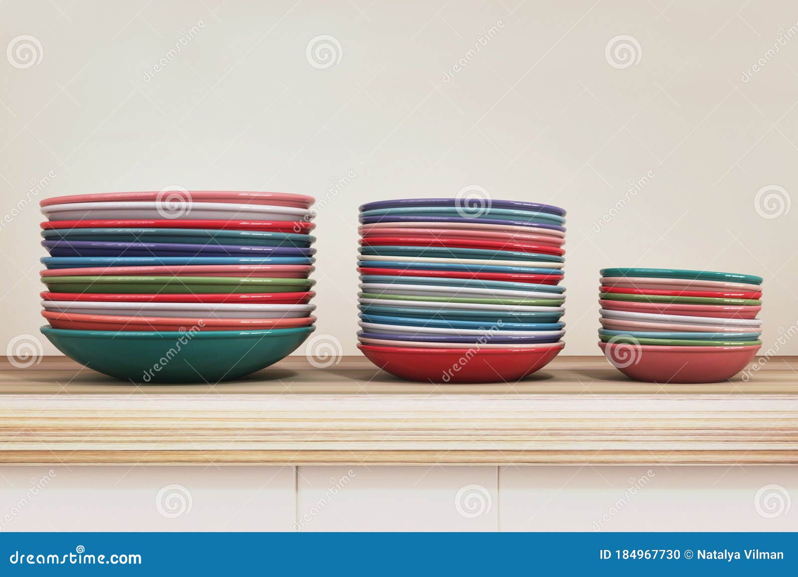 Multi-colored Plates Standing in Piles in Strict Order on the Table. 3d ...