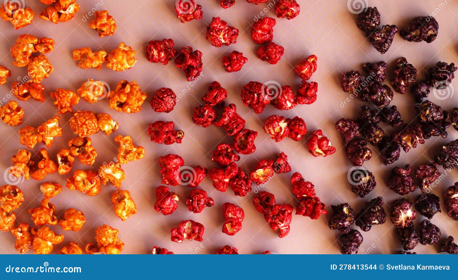 Multi-colored Popcorn in Caramel Glaze Scattered in Rows on a Pink ...