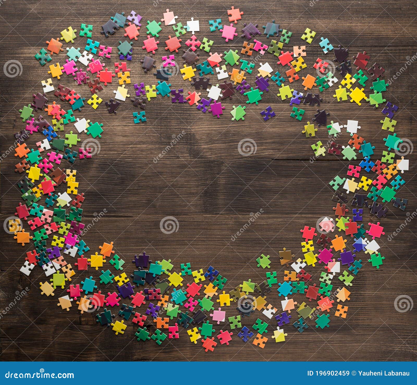 Multi-colored Puzzle on a Wooden Table Top View with an Empty Space for ...