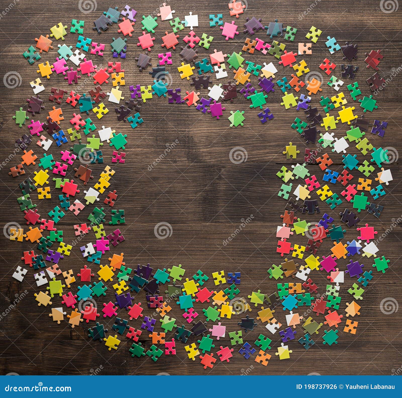 Multi-colored Puzzle on a Wooden Table Top View with an Empty Space for ...
