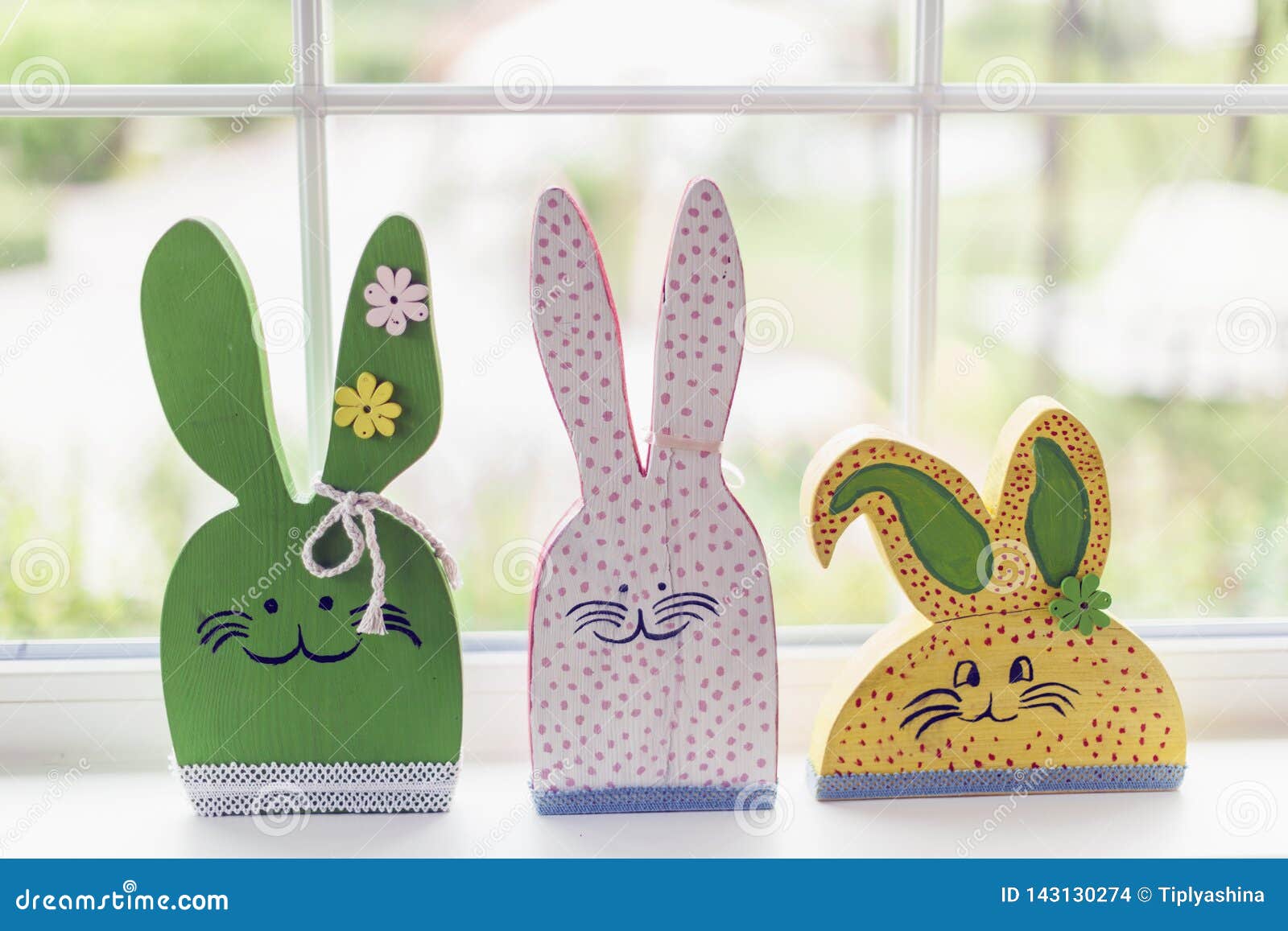 Multi-colored Rabbits Carved from Wood on the Window Stock Photo ...
