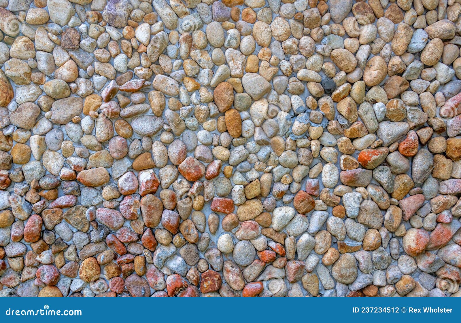 Rounded Pebbles Embedded in a Concrete Wall Stock Photo - Image of ...