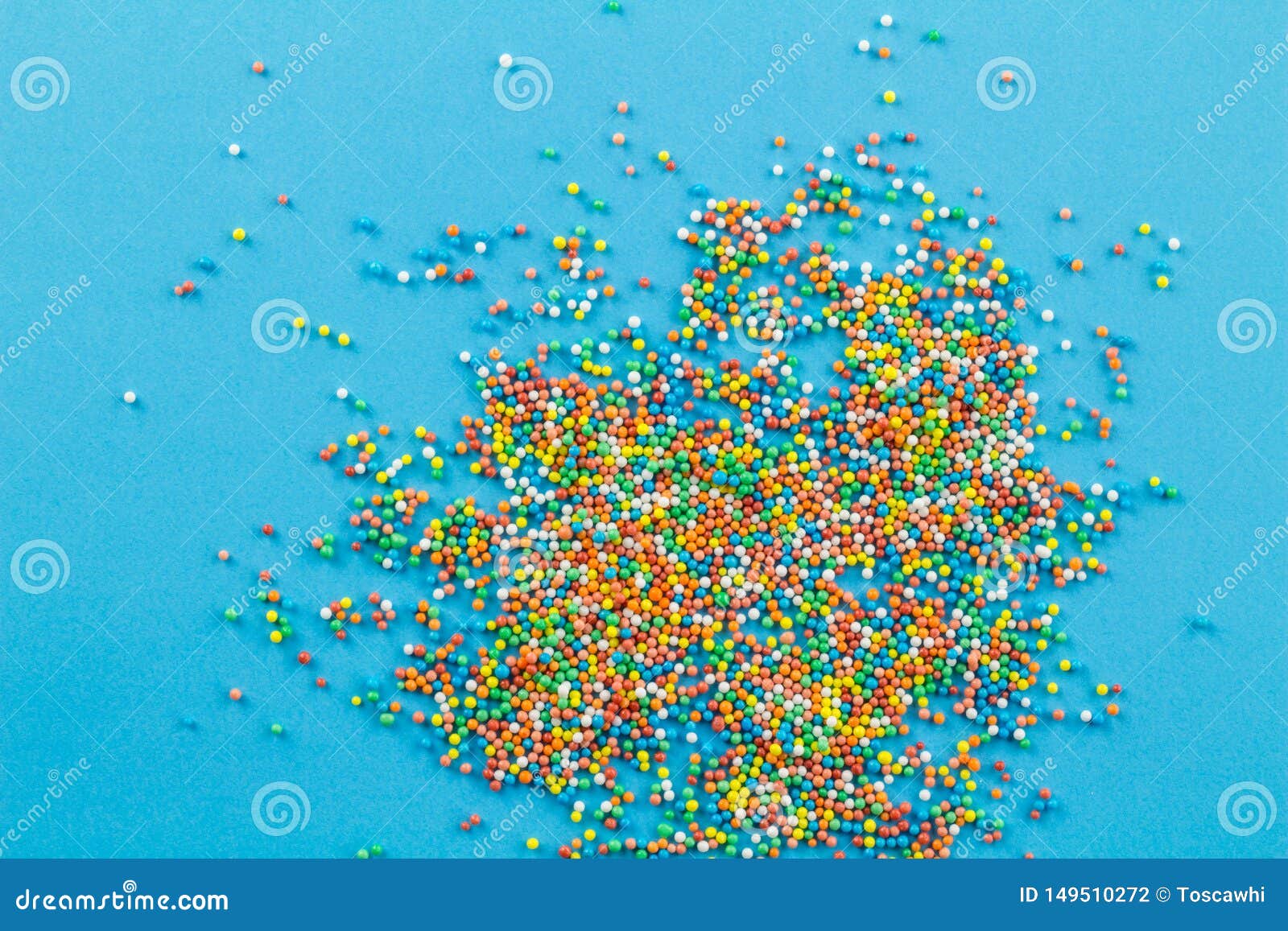 Multi-colored Round Sprinkles Heaped and Scattered on Blue Background ...