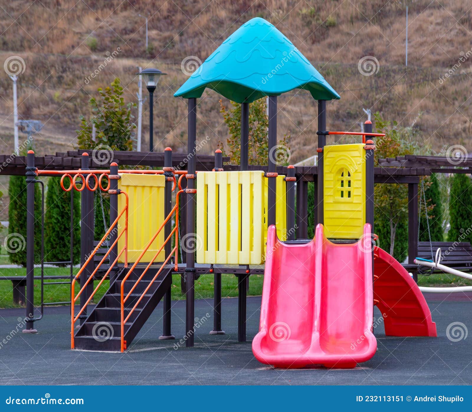 Multi-colored Slides and Swings on Playground. Stock Image - Image of ...