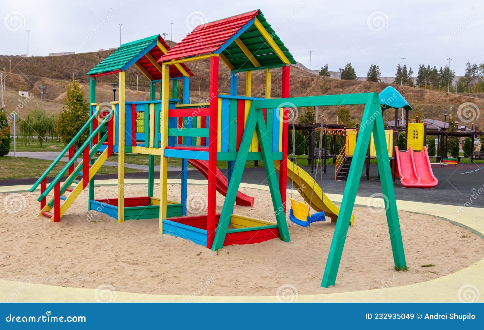 Multi-colored Slides and Swings on Playground. Stock Image - Image of ...