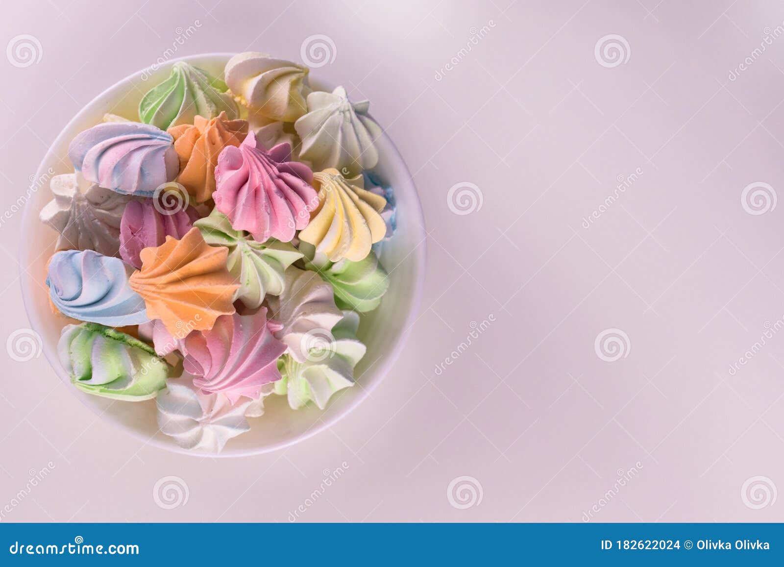 Multi-colored Small Meringues in a Plate on a White Background. View ...