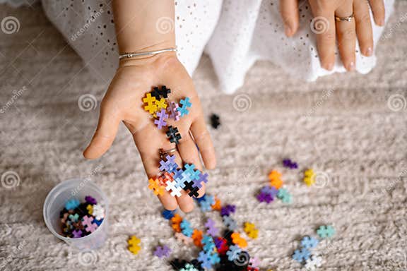 A Multi-colored Small Puzzle Set in a Womans Hands Stock Image - Image ...