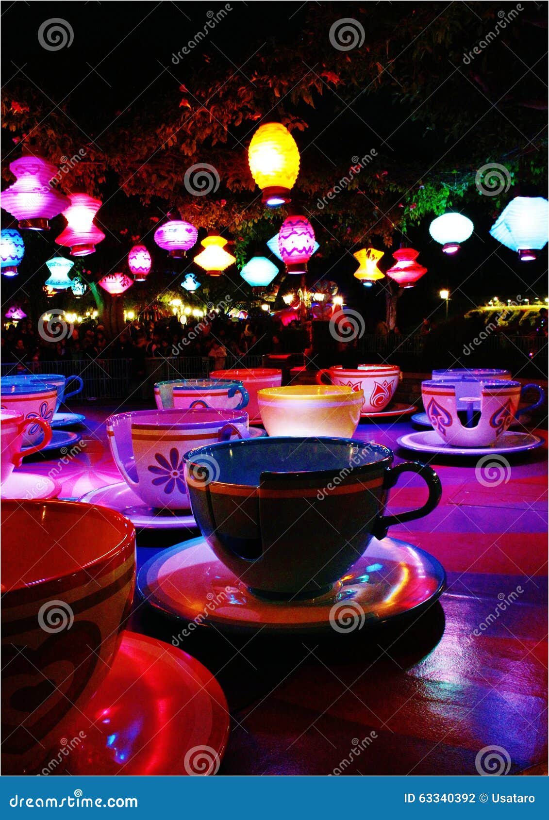 Multi Colored Tea Cups on Table Against Illuminated Lamps Hanging from ...