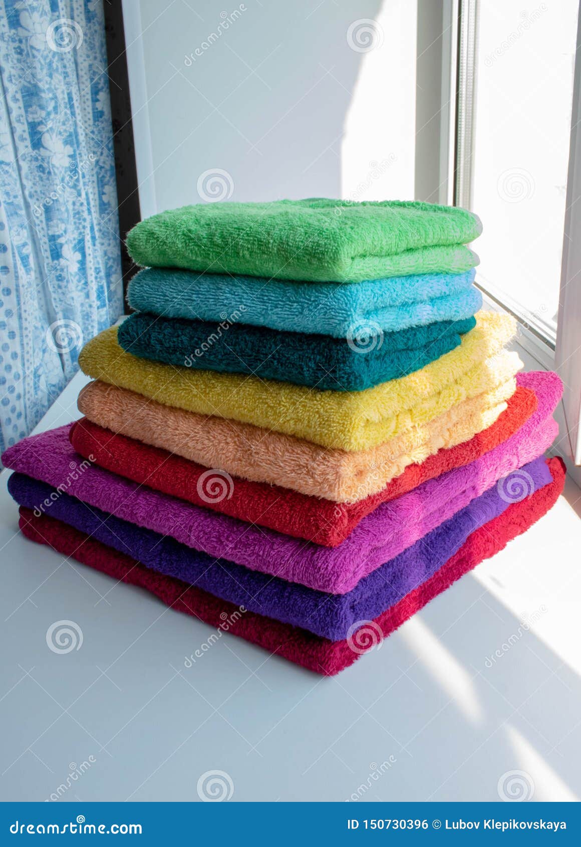 Multi-colored Terry Towels in a Stack on the Window Stock Photo - Image ...