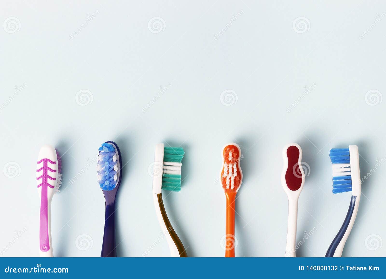 Multi-colored Toothbrushes on a Blue Background, Copy Space Stock Photo ...