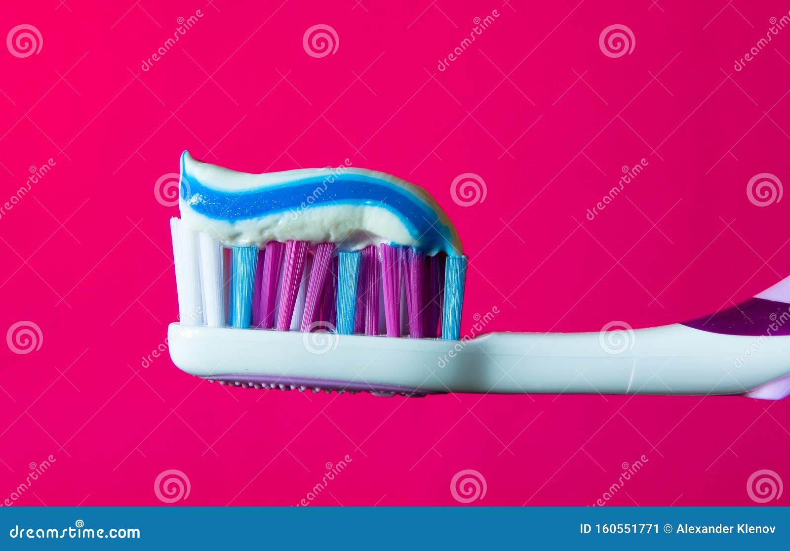A Multi-colored Toothpaste is Applied To a Multi-colored Toothbrush ...