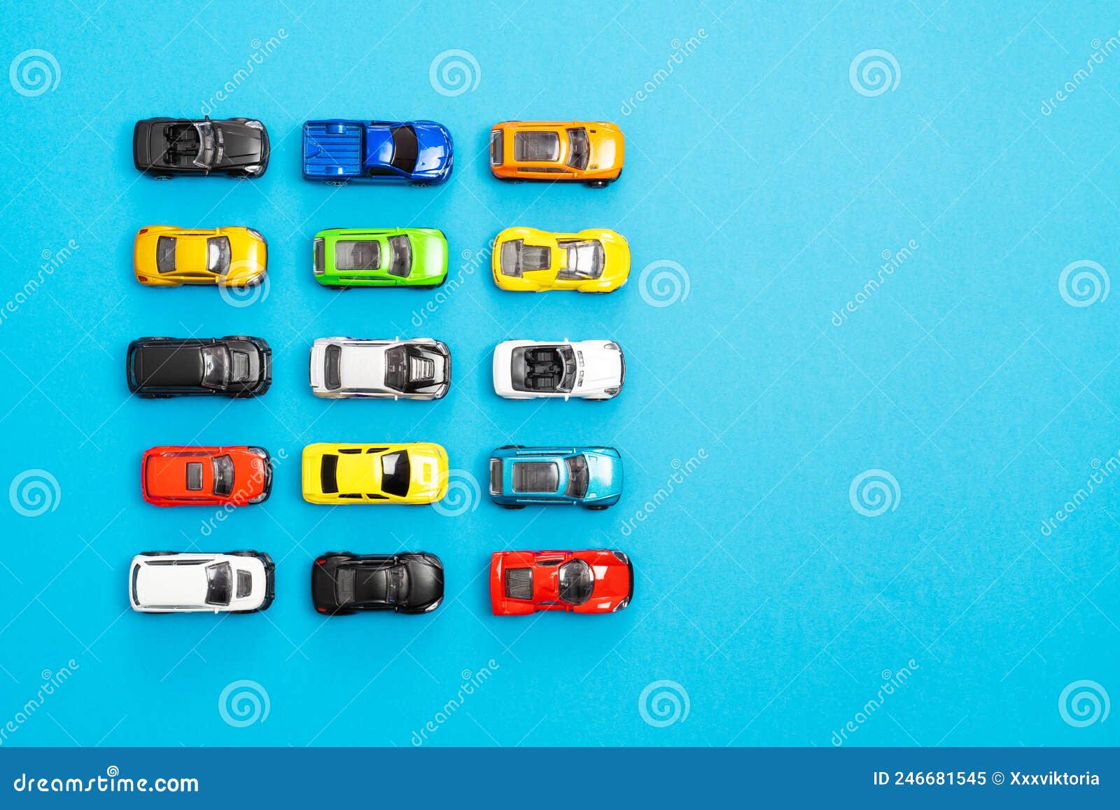 Multi Colored Toy Cars Lined Up in Rows on Blue Background with Empty ...