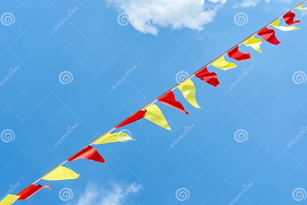 Multi Colored Triangular Flags Develop on the Background of Blue Sky ...