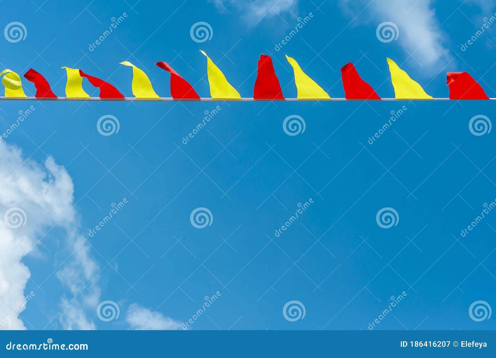 Multi Colored Triangular Flags Develop on the Background of Blue Sky ...