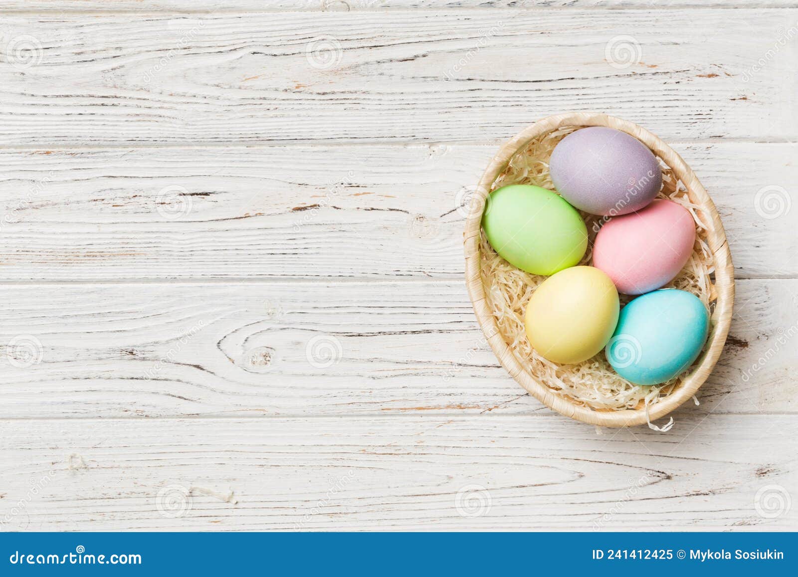 Multi Colors Easter Eggs in the Woven Basket on Colored Background ...