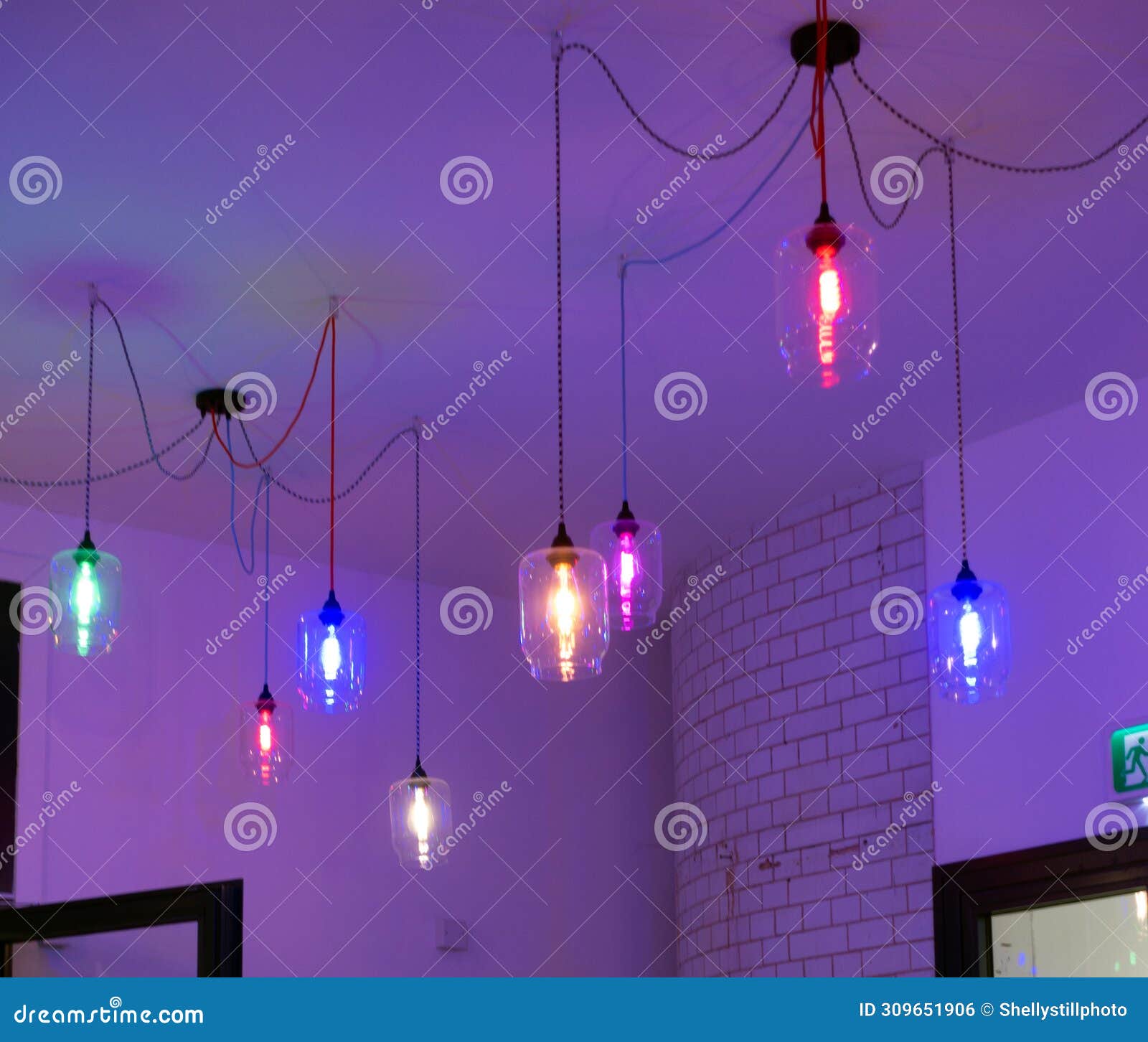Multi-coloured Bulbs Hanging from a Ceiling and Glowing Stock Photo ...