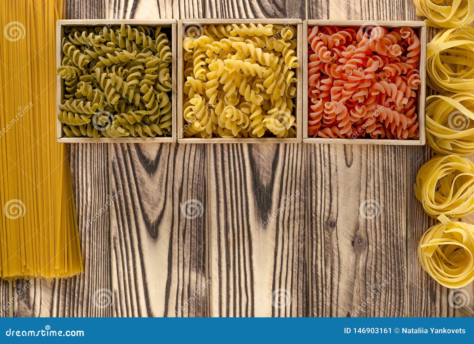 Multi-coloured Pasta in the Form of Spirals Lies in Square Wooden Boxes ...