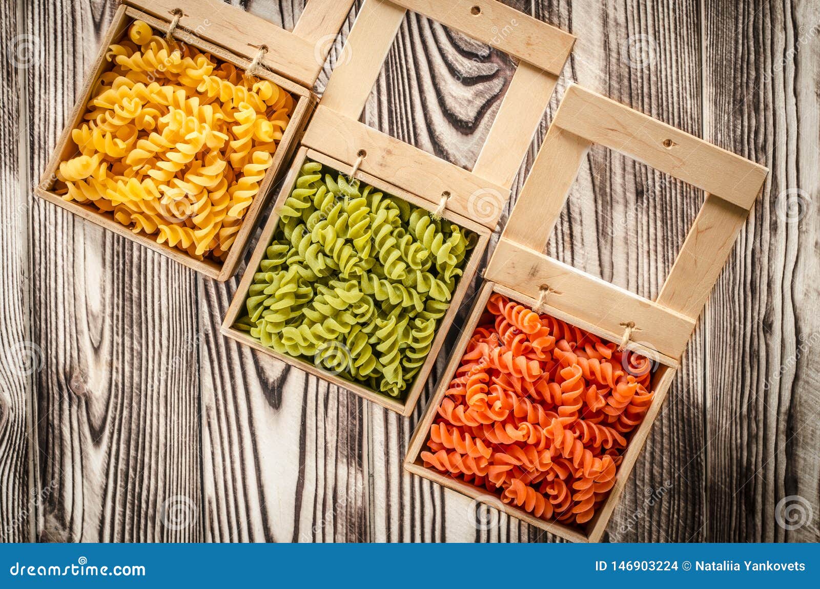 Multi-coloured Pasta in the Form of Spirals Lies in Square Wooden Boxes ...