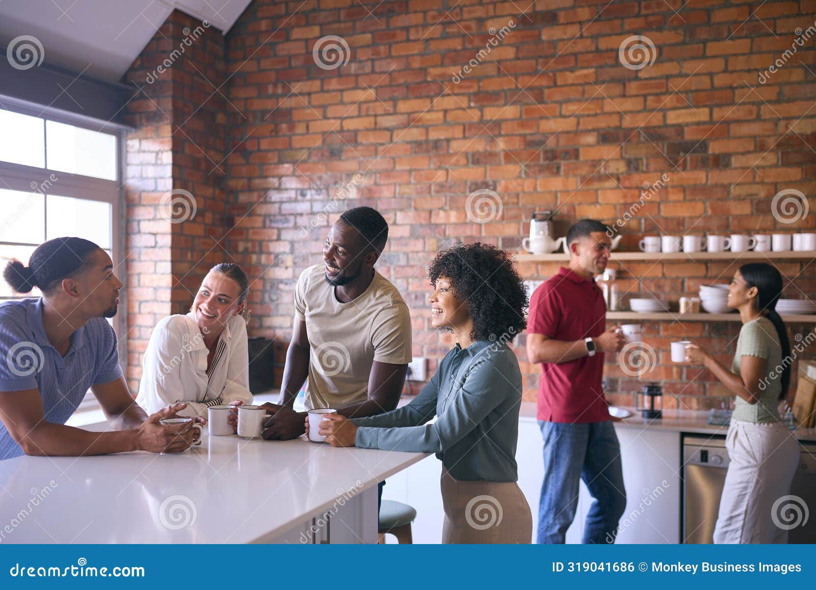 Multi-Cultural Business Team Taking Coffee Break in Kitchen Area of ...