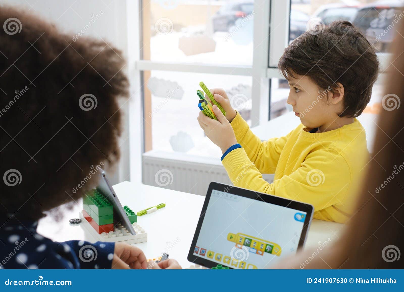 Multi Ethnic Children at Technology Lesson Coding Robot on Tablet Stock ...