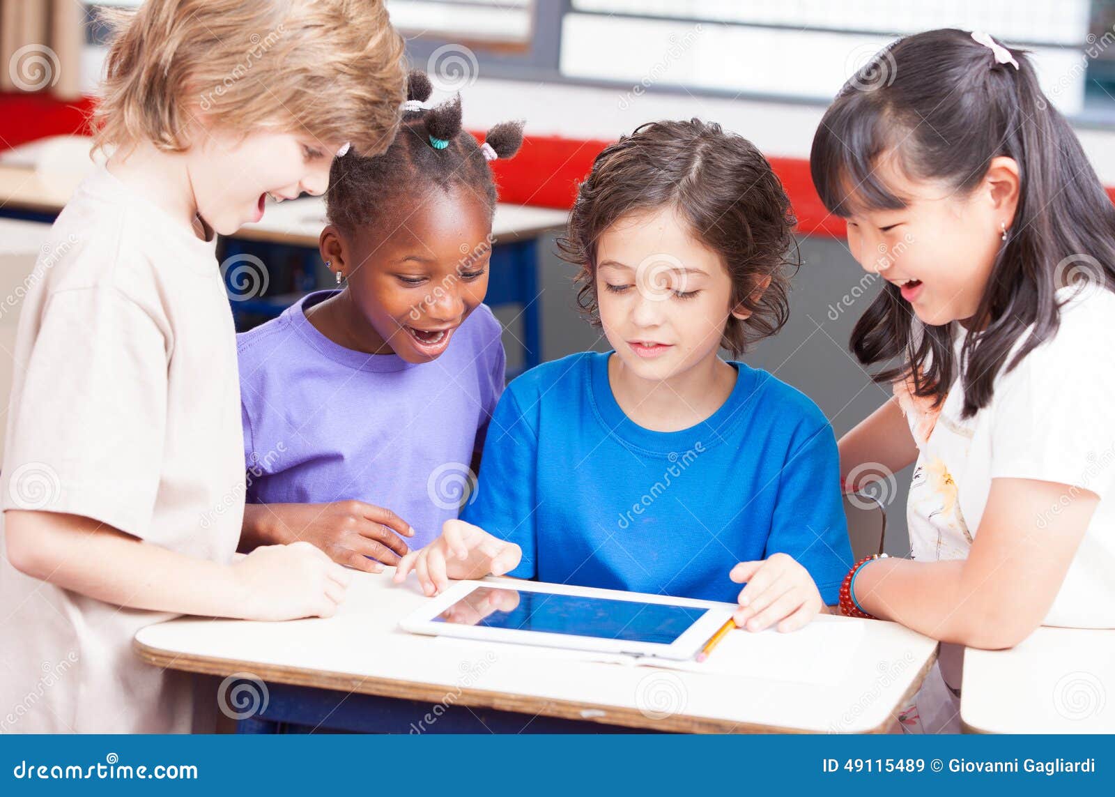 Multi-ethnic Classroom Playing with Tablet. Happy School Concept Stock ...