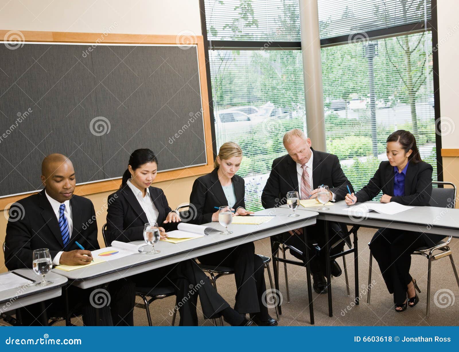 Multi-ethnic Co-workers Sitting Around Table Stock Photo - Image of ...