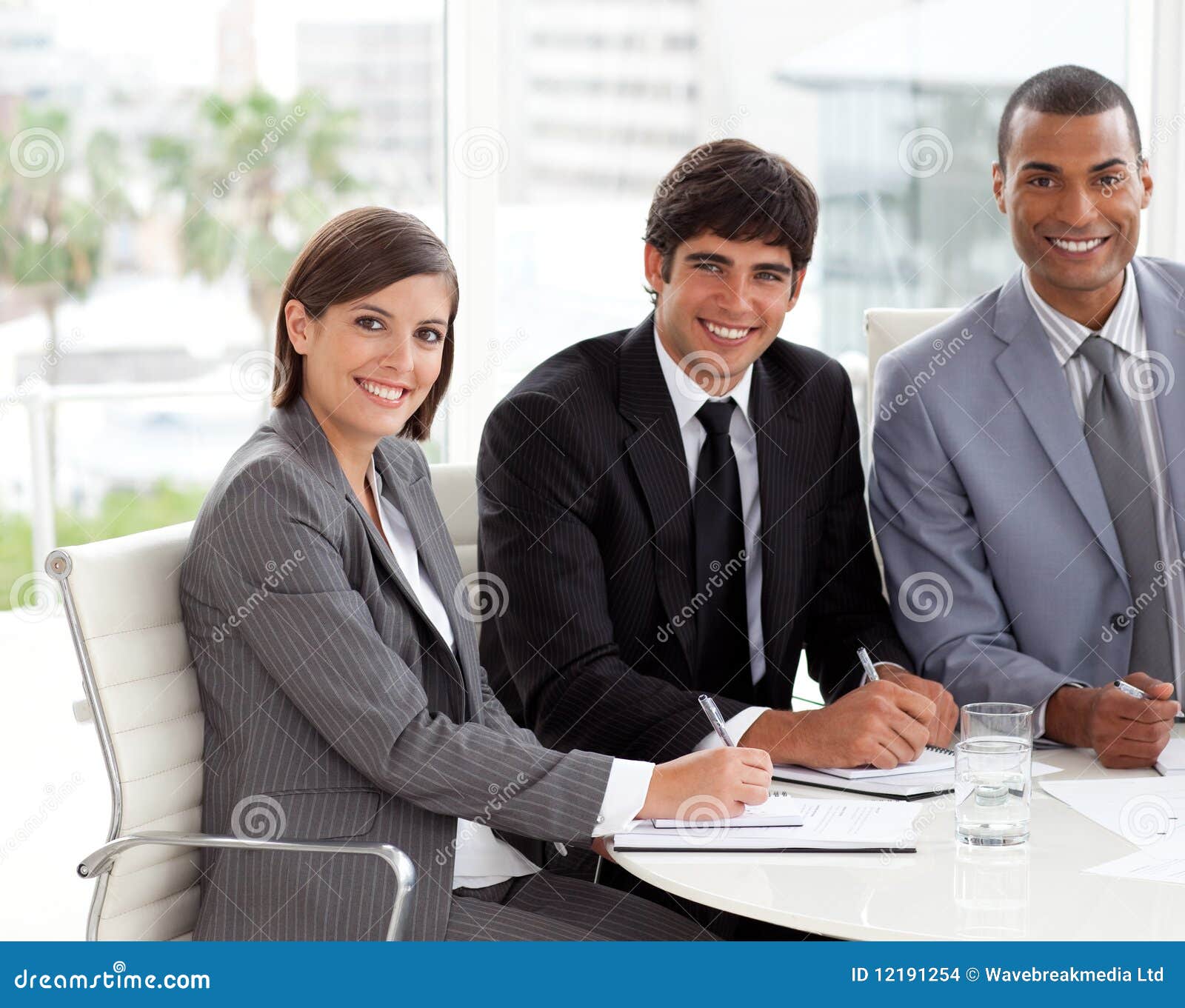 Multi-ethnic Co-workers Smiling at the Camera Stock Photo - Image of ...