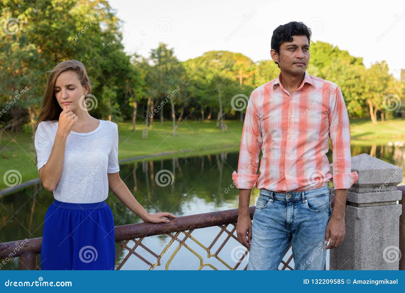 Multi Ethnic Couple Thinking while Looking Sad on the Bridge of Stock ...