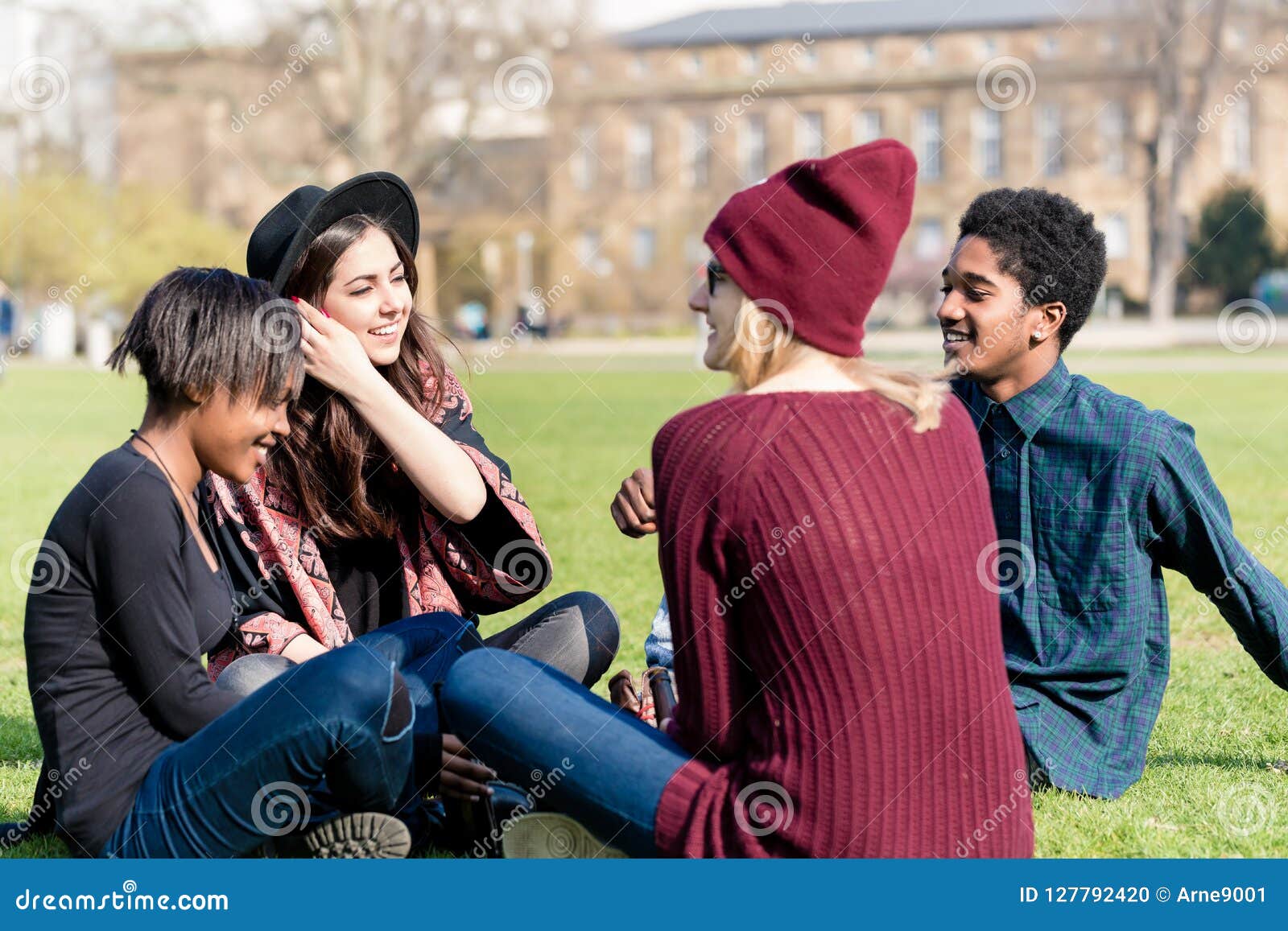 Multi Ethnic Friends Sitting Together in the Park Stock Photo - Image ...