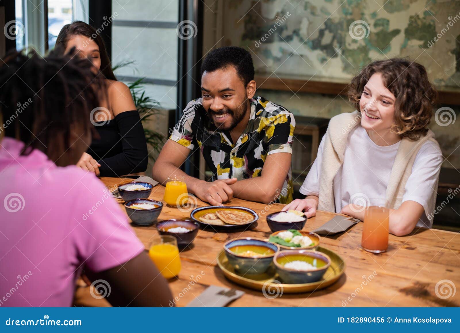 Multi-ethnic Group of Friends Having a Good Time in a Cafe Stock Photo ...