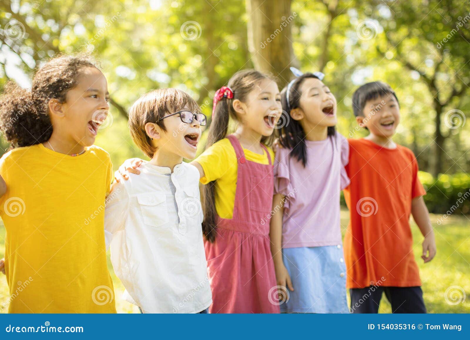 Multiethnic Group of School Children Laughing and Embracing Stock Photo ...