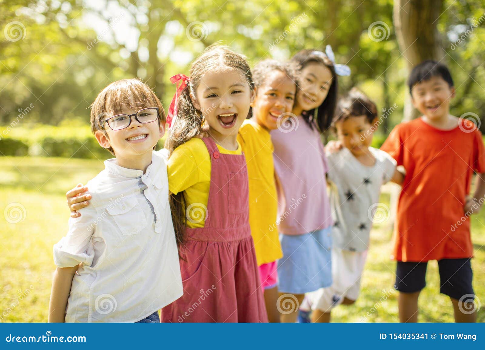 Two Children Laughing In An Orange Hammock Outdoors, Enjoying Nature ...