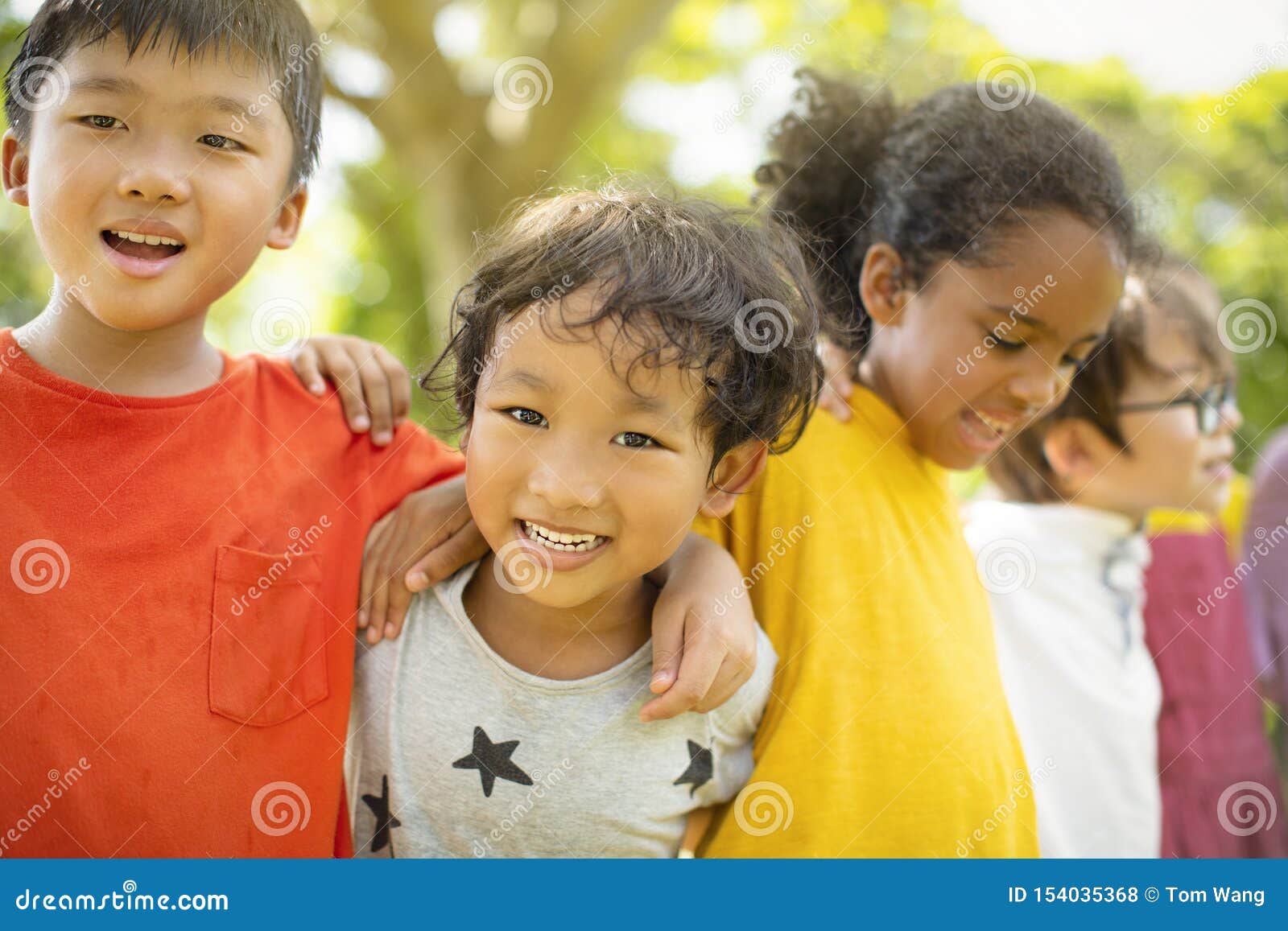 Multiethnic Group of School Children Laughing and Embracing Stock Photo ...