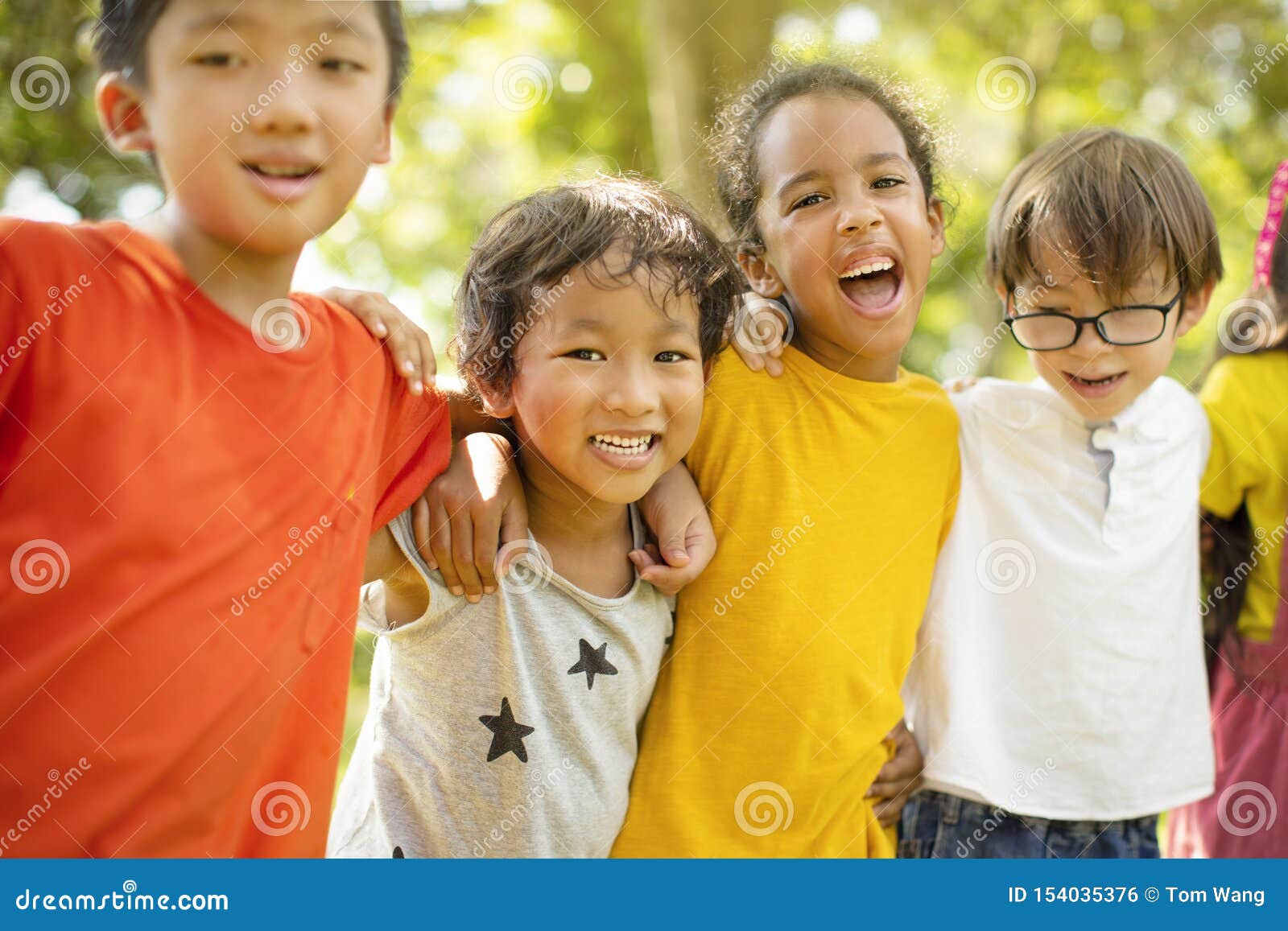 Multiethnic Group of School Children Laughing and Embracing Stock Photo ...