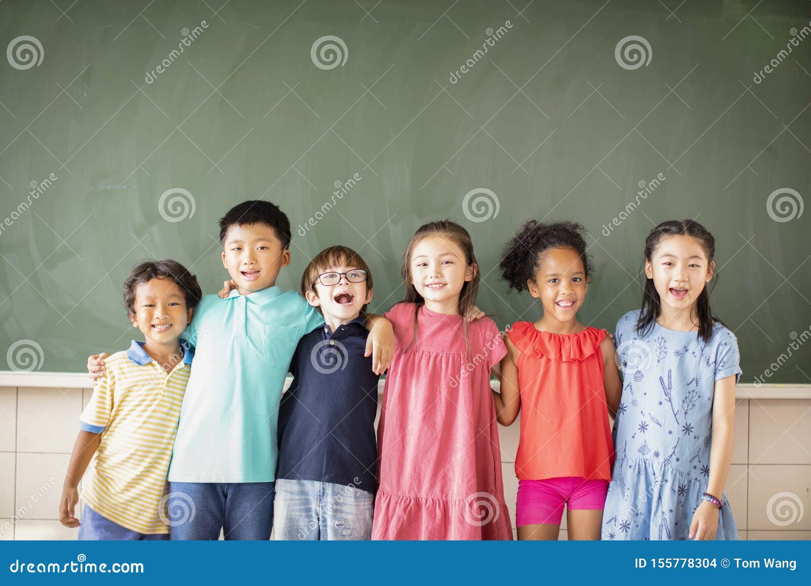 Multiethnic Group of School Children Standing in Classroom Stock Photo ...