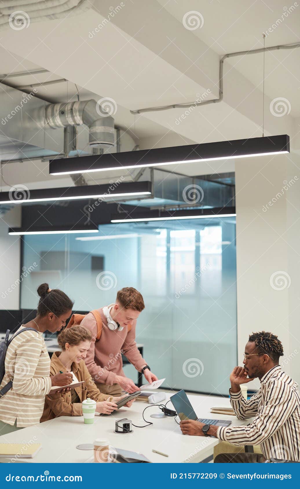 Multi Ethnic Group of Students Working at Table Stock Image - Image of ...