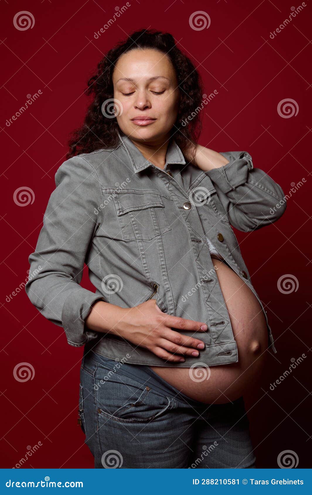 Multi Ethnic Pregnant Woman In Casual Denim Clothes Posing With Her