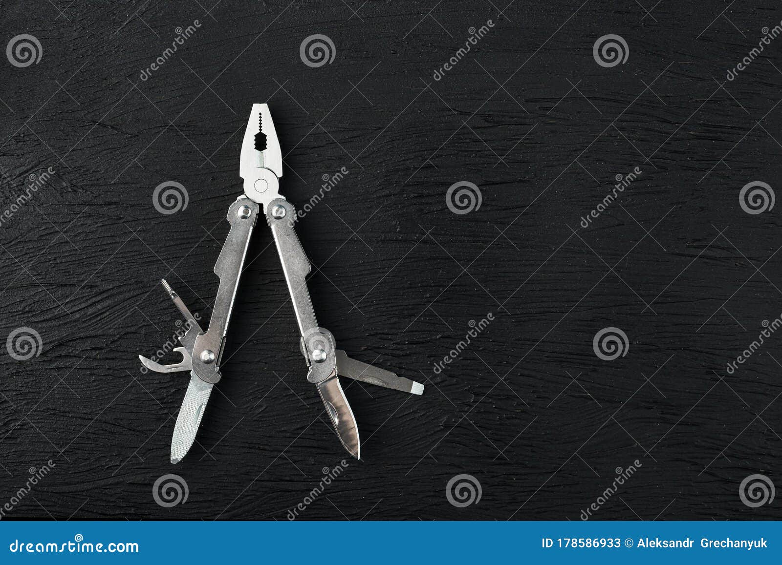 Multi-functional Tool on a Black Textural Background Stock Image ...