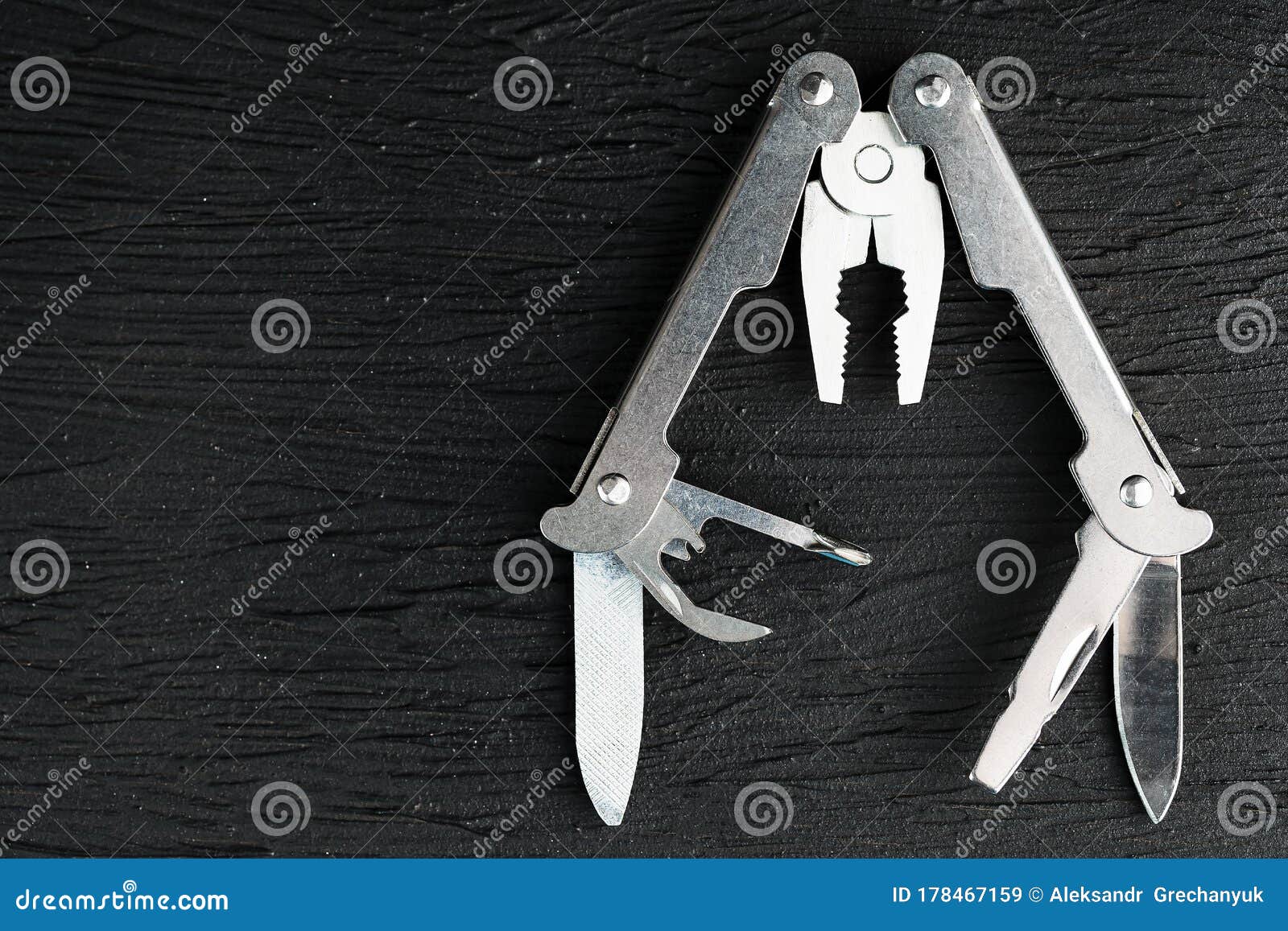 Multi-functional Tool on a Black Textural Background. Stock Image ...