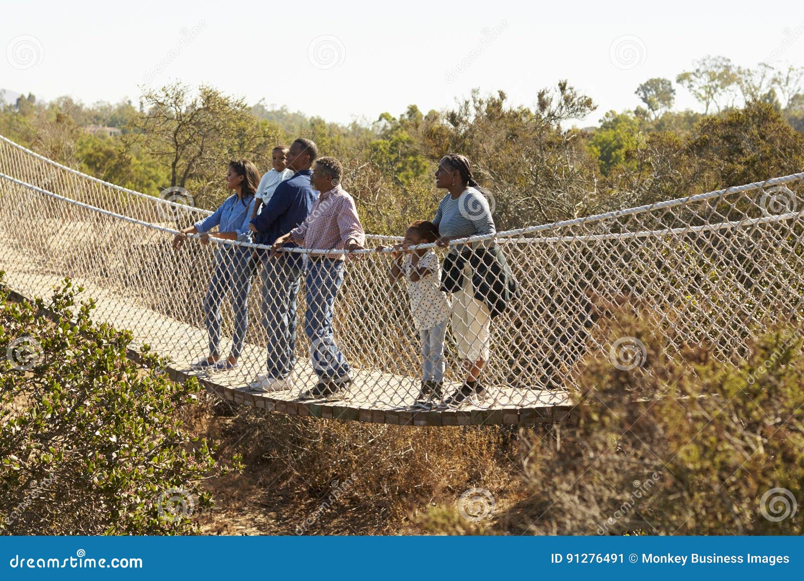 Multi Generation Family Crossing Rope Bridge Together Stock Image ...