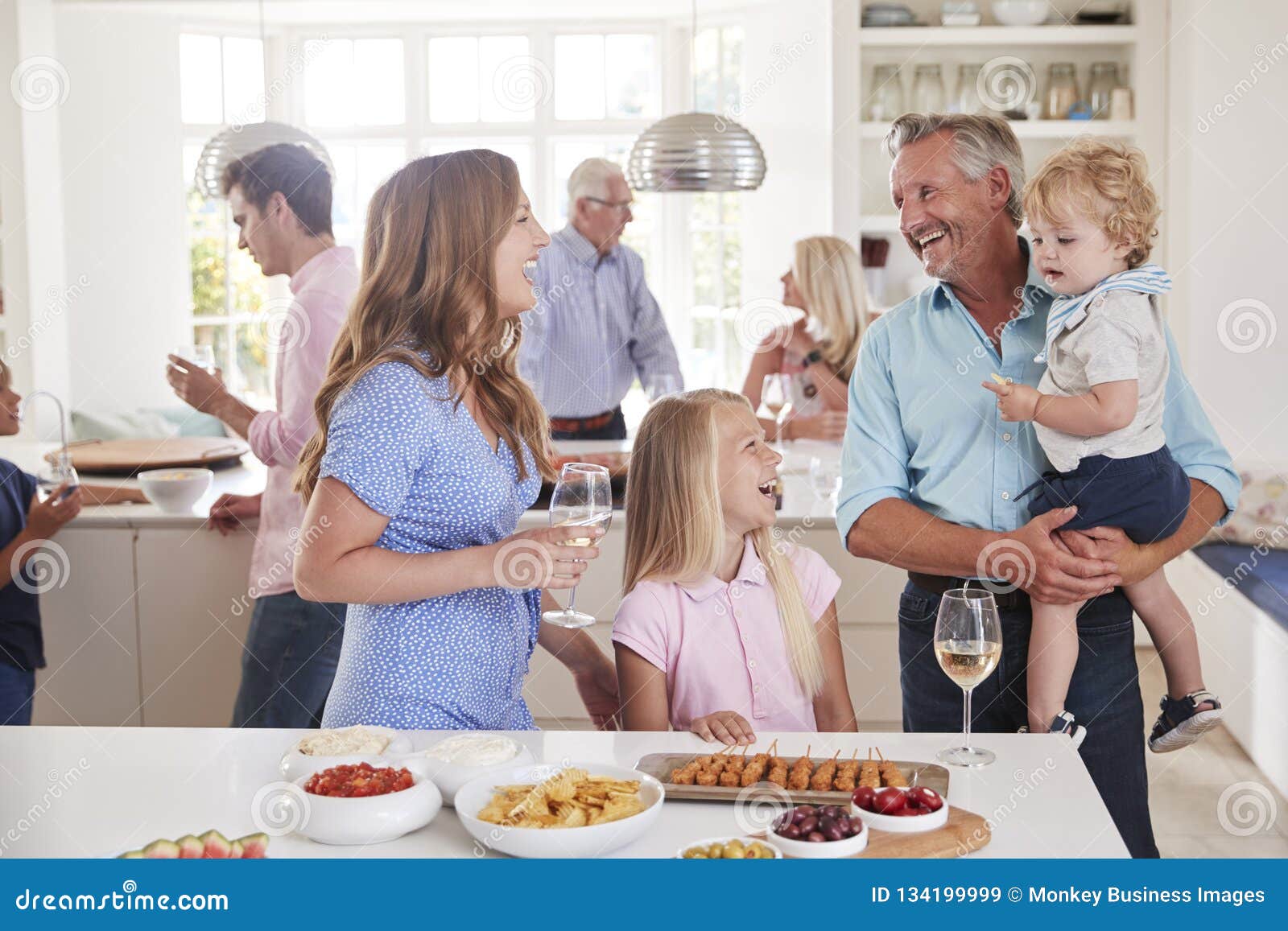 Multi-Generation Family and Friends Gathering in Kitchen for ...