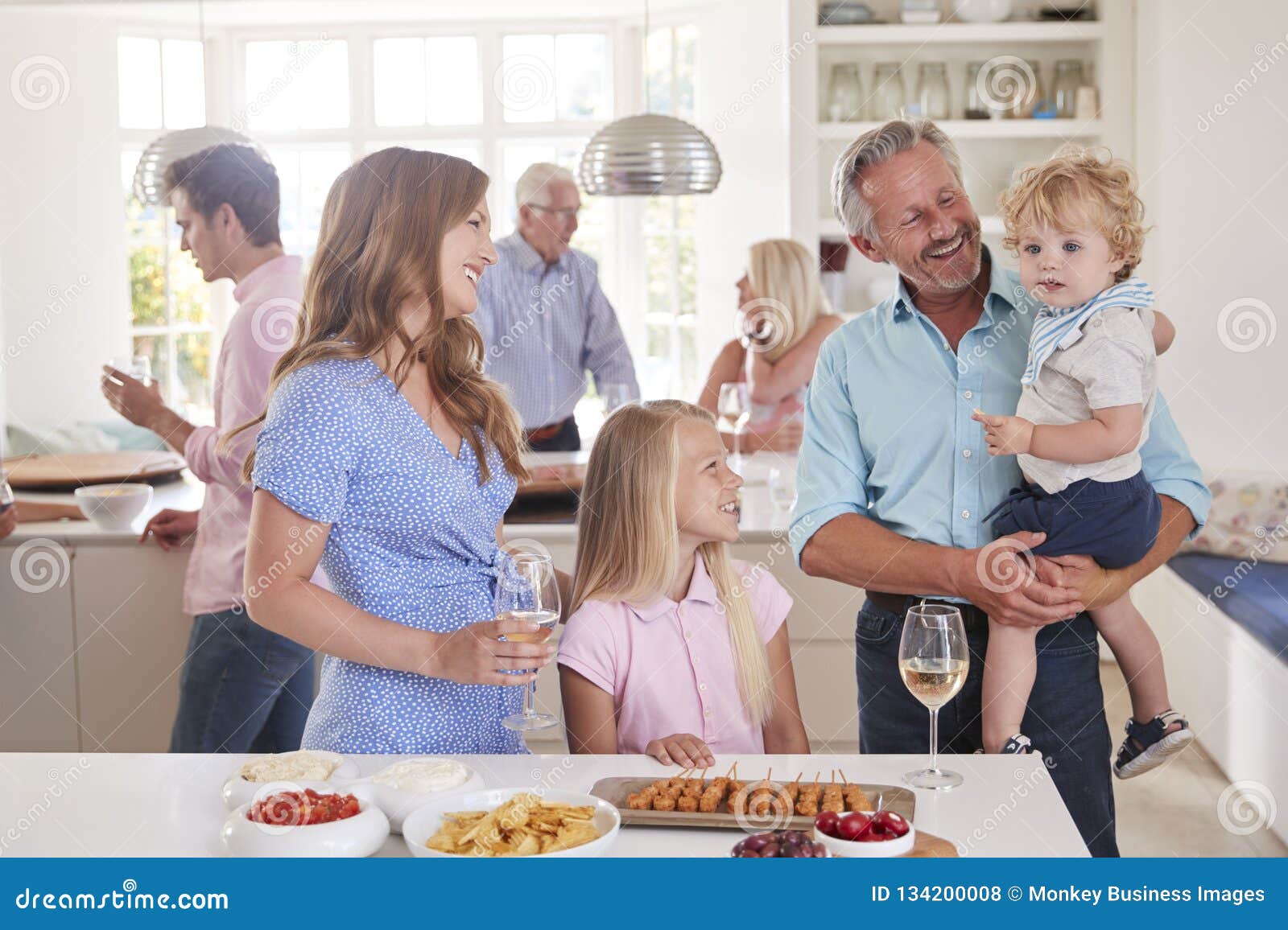 Multi-Generation Family and Friends Gathering in Kitchen for ...