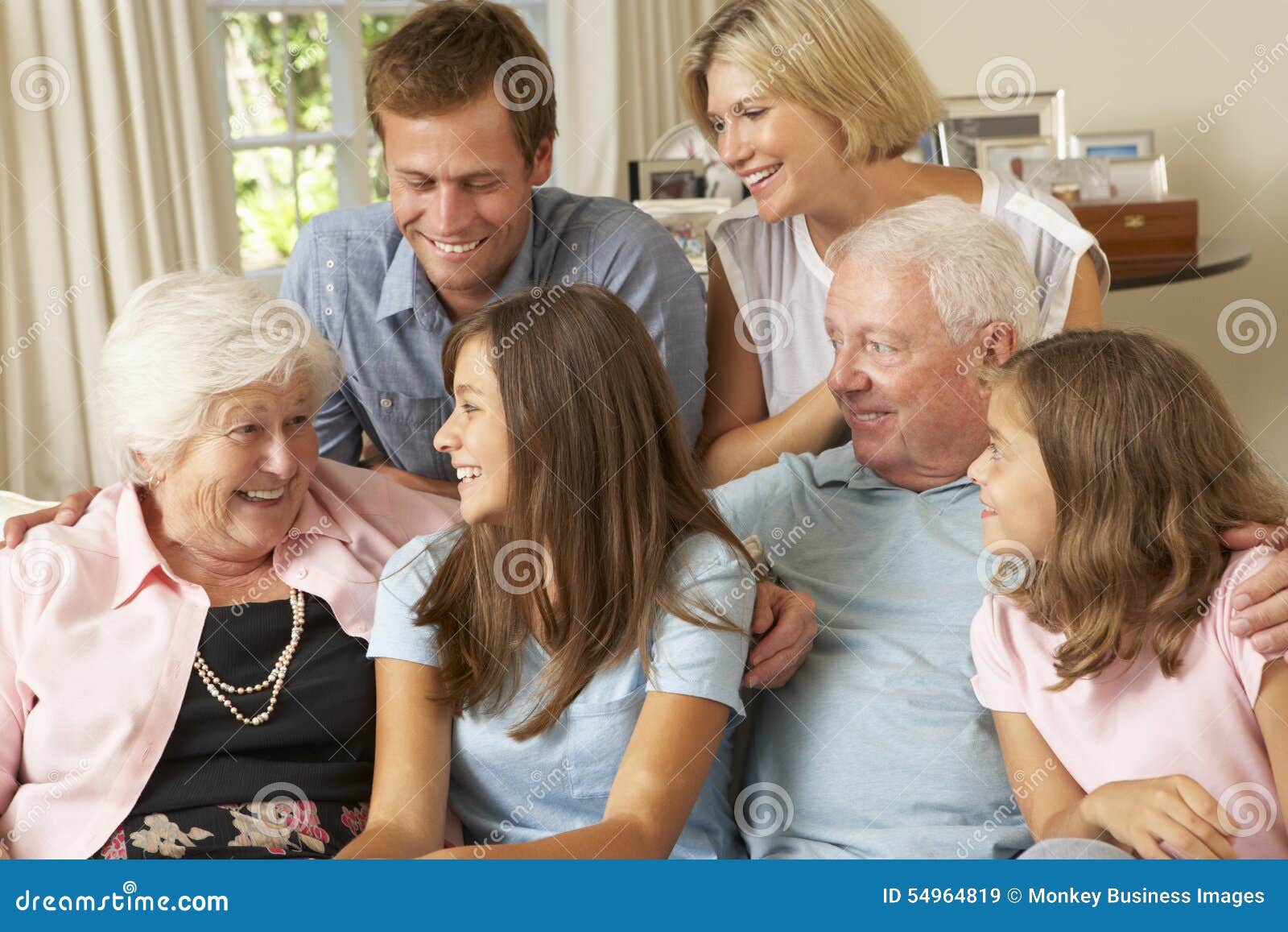 Multi Generation Family Group Sitting on Sofa Indoors Stock Image ...