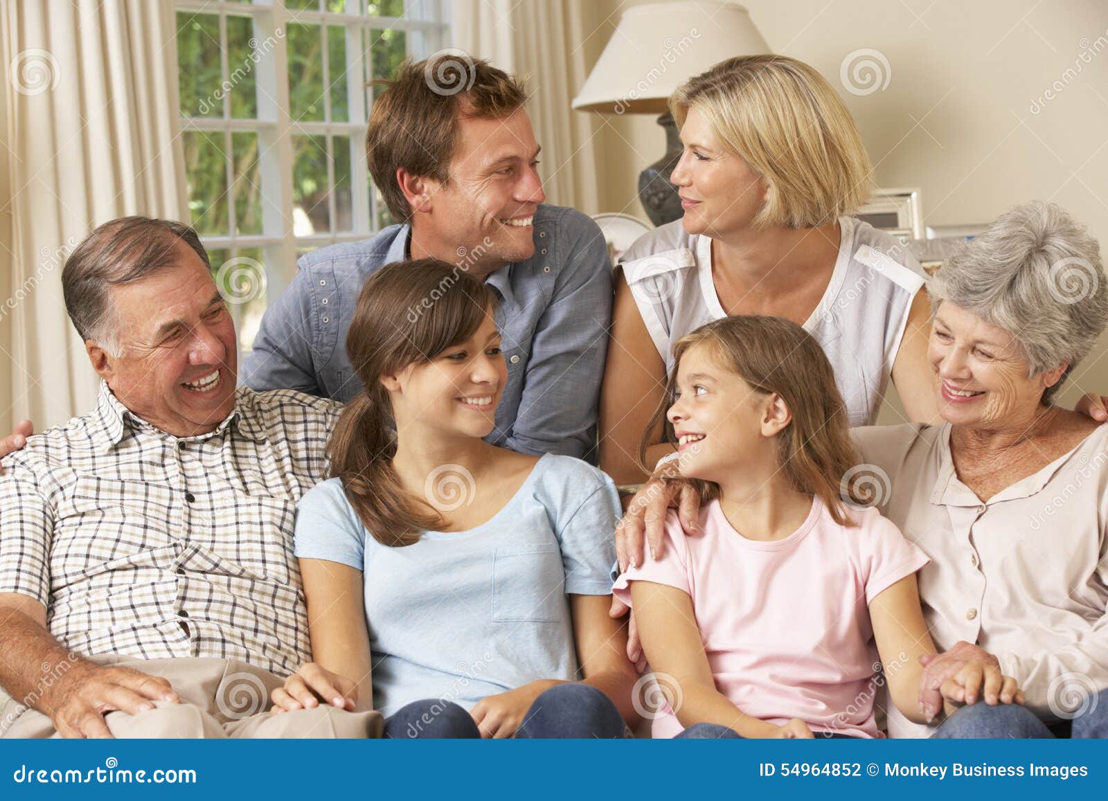 Multi Generation Family Group Sitting on Sofa Indoors Stock Photo ...