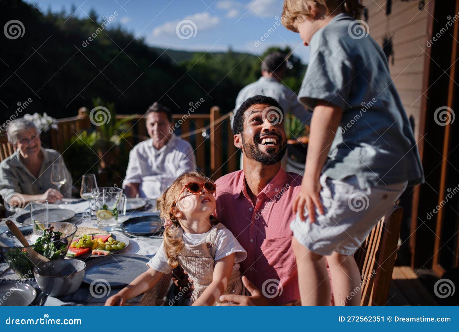 Multi Generation Family Party Outside in the Backyard on Patio. Stock ...