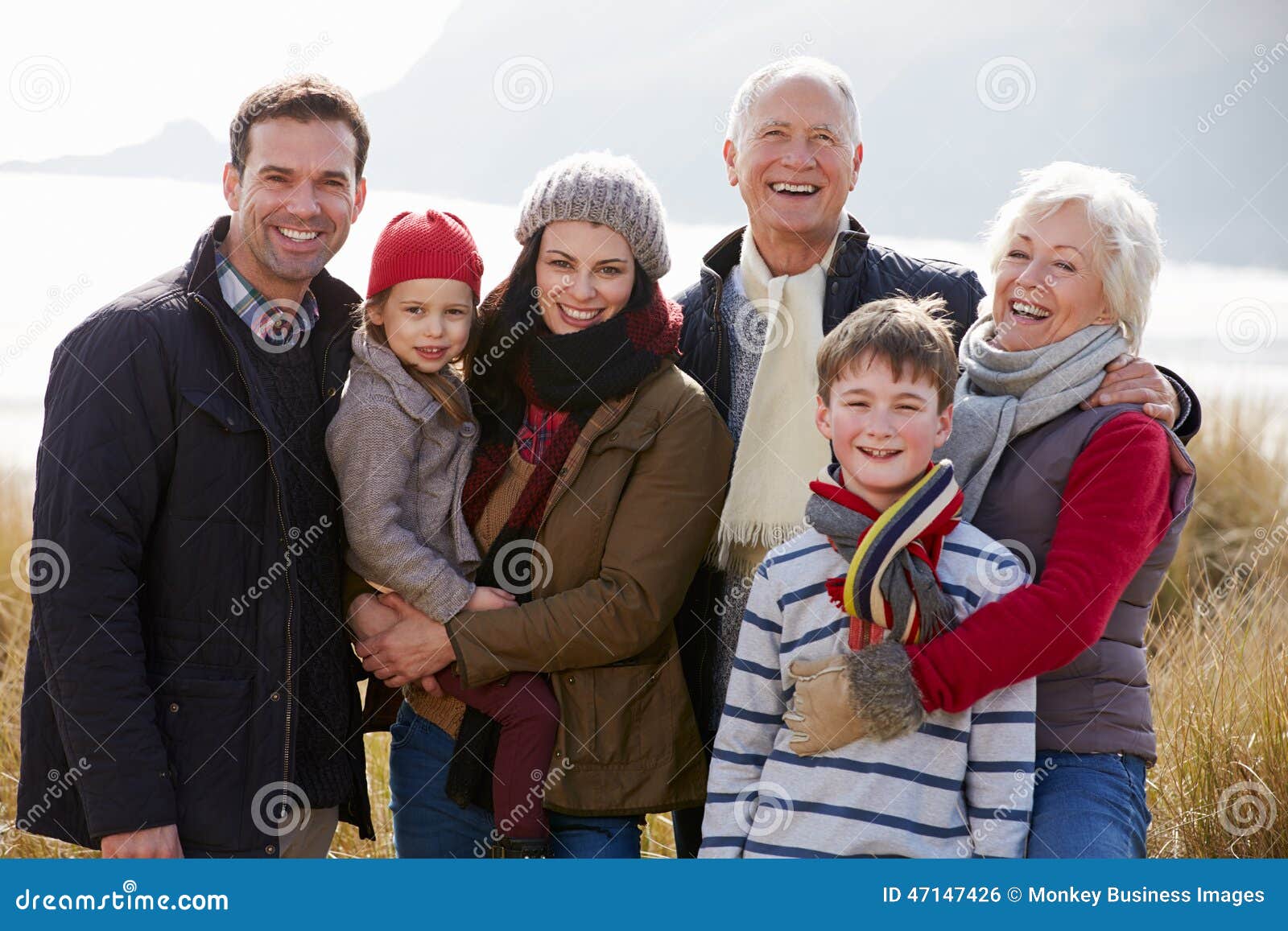 Multi Generation Family in Sand Dunes on Winter Beach Stock Photo ...